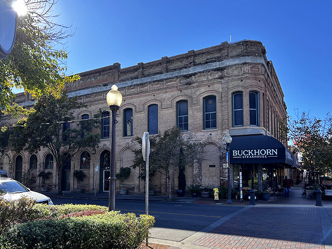 The historic brick fa&ccedil;ade of Buckhorn Steakhouse glows golden at sunset, a beacon of carnivorous delights in downtown Winters that's impossible to resist.