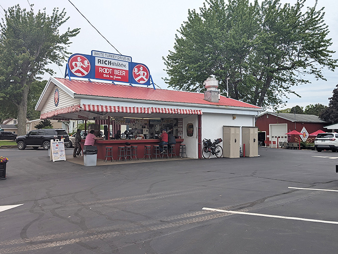 The iconic White Turkey Drive-In stands proudly with its red roof and striped awnings, a time capsule of Americana serving happiness on a tray since generations.