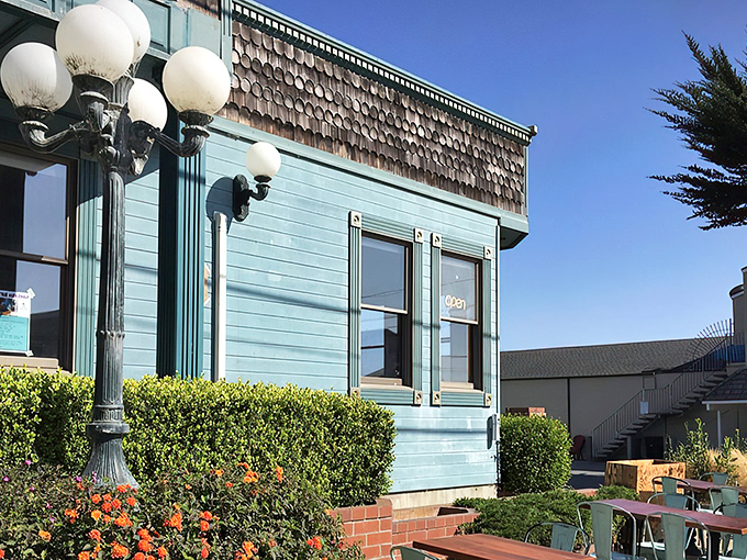 The turquoise Victorian building housing Breakwater Barbecue stands like a coastal mirage for meat lovers, where ocean breezes meet smoky perfection.