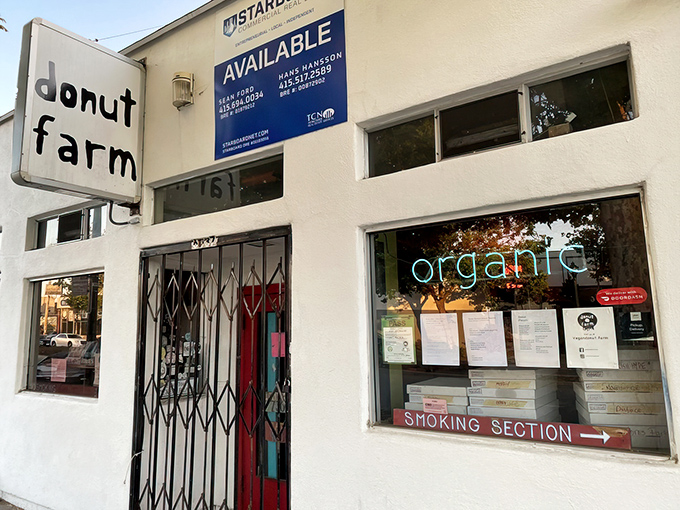 The unassuming exterior of Donut Farm, where Berkeley's vegan revolution quietly unfolds behind a simple sign and iron gate.