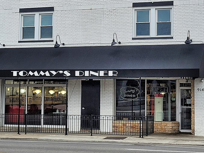 Tommy's Diner stands proudly on West Broad Street, its classic black awning and white brick exterior a beacon for comfort food pilgrims across Ohio.