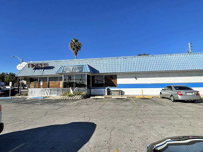 The iconic blue-roofed exterior of Papa's stands like a beacon for breakfast lovers, promising comfort food salvation under the Florida sun.