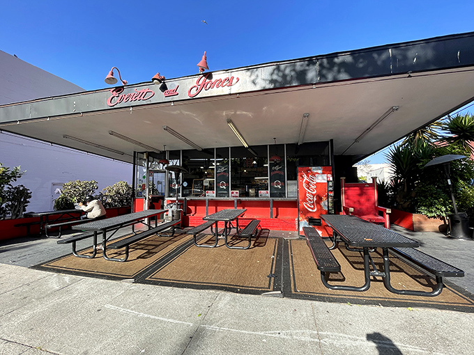 The iconic red and black storefront beckons like a barbecue lighthouse on San Pablo Avenue, promising smoky treasures within.
