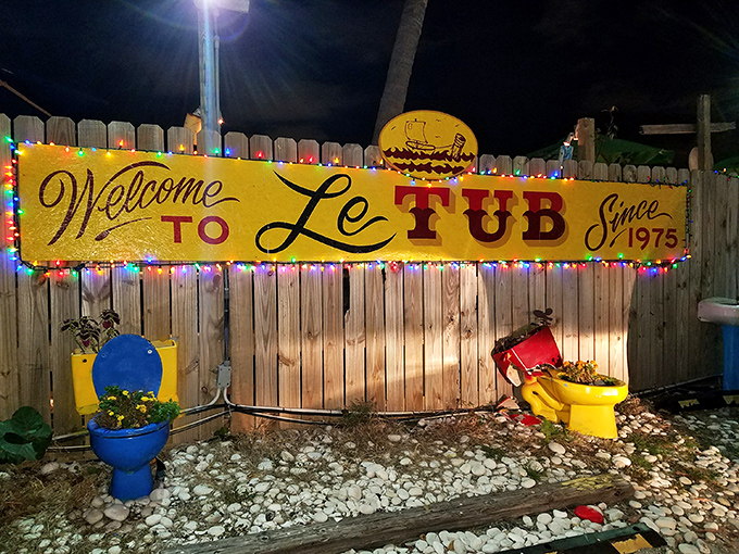 The unassuming wooden fence and yellow sign of Le Tub are Florida's version of a speakeasy entrance&mdash;secrets and seafood await behind these weathered boards.