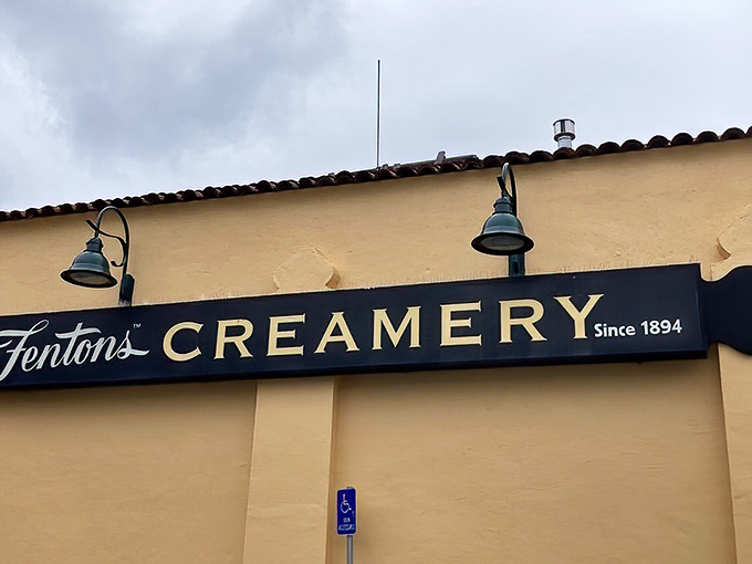 The sunshine-yellow exterior of Fentons Creamery stands like a beacon of sweet promises, its vintage sign a time portal to simpler days.