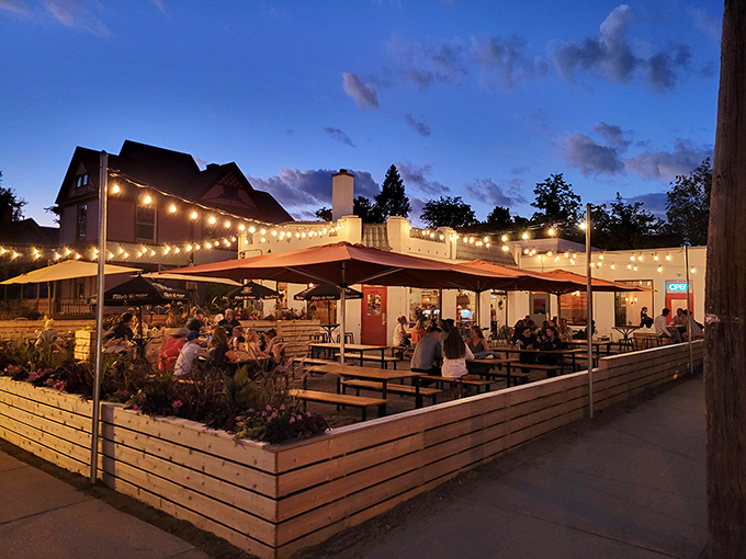 The patio paradise at Donkey Taqueria sits beneath string lights, with the iconic purple Victorian house creating a perfect backdrop for your taco-fueled evening.