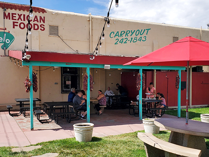 The unassuming exterior of El Modelo stands like a culinary lighthouse in Albuquerque's Barelas neighborhood, beckoning hungry pilgrims with its iconic Zia symbol.