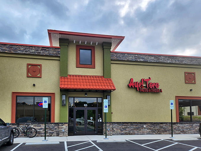 The golden-hued exterior of Aye! Toro stands like a beacon of culinary promise in Pittsboro, its terracotta accents and stonework hinting at the authentic flavors waiting inside.