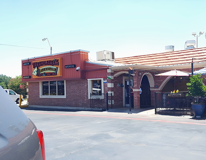 The bright red exterior of Tarahumara's stands like a beacon of culinary promise in Norman, beckoning hungry travelers with its distinctive signage and welcoming patio.