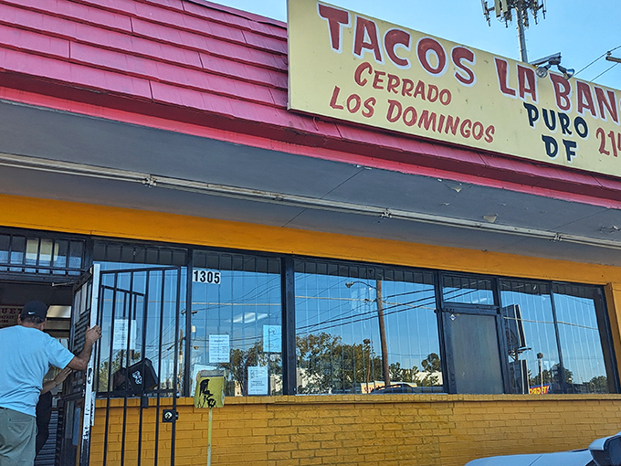 The bright red exterior of Tacos La Banqueta stands out like a beacon of hope for hungry travelers. No fancy architecture needed when the food speaks this loudly.