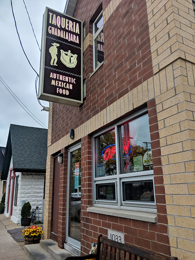 The unassuming brick exterior with that eye-catching pink bench is like a secret handshake &ndash; those who know, know this is where Madison's burrito magic happens.