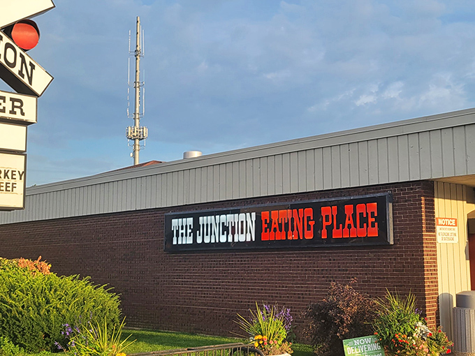 The railroad crossing sign perched atop this unassuming DeKalb diner isn't just decoration&mdash;it's a promise of the journey your taste buds are about to take.