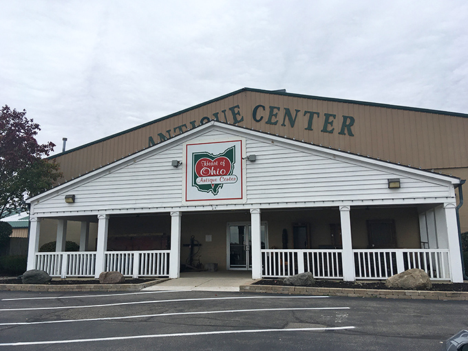 The white-columned porch of Heart of Ohio Antique Center beckons like a Southern mansion that swallowed a warehouse. Treasure hunting begins at the threshold.