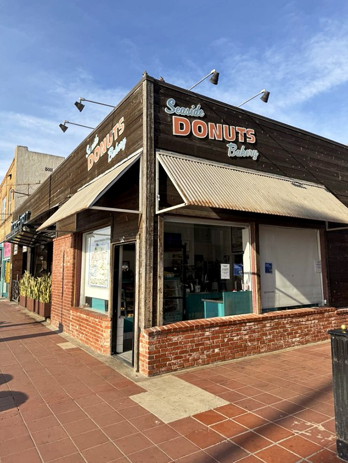 The unassuming wooden facade of Seaside Donuts Bakery stands like a sweet sentinel on Newport Beach's sidewalk, promising simple pleasures done extraordinarily well.