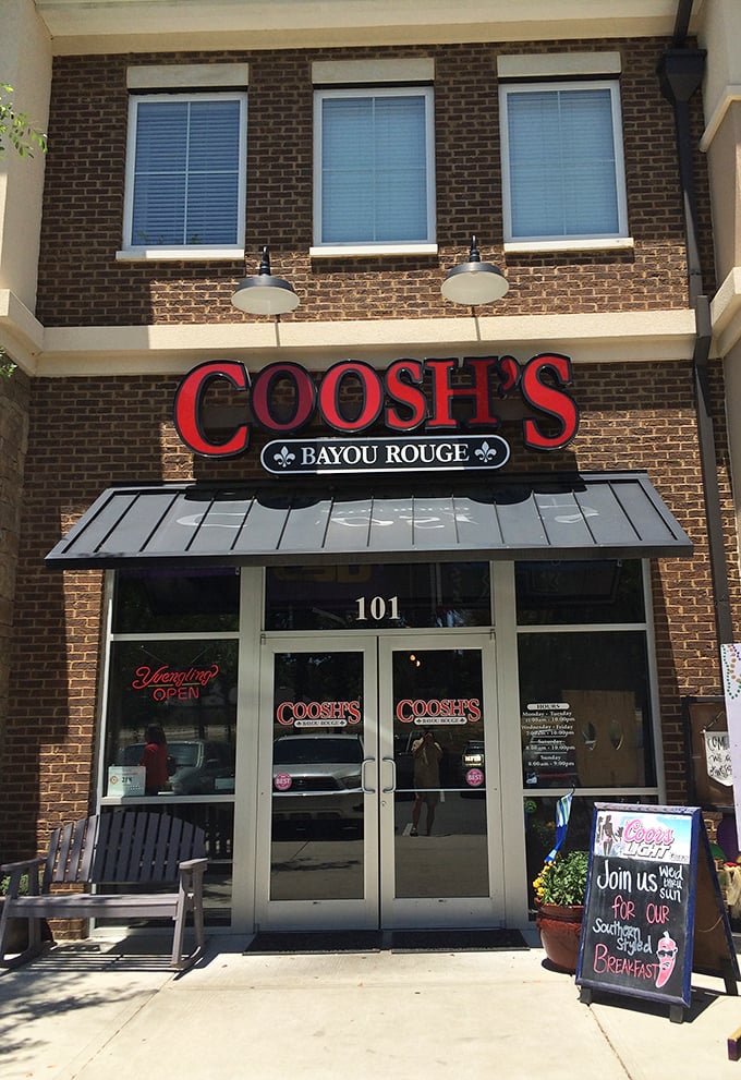 The brick facade of Coosh's Bayou Rouge beckons with its bold red signage &ndash; a little slice of Louisiana hospitality waiting to welcome hungry Tallahassee visitors.