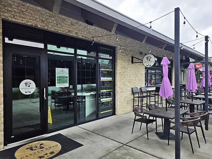 Modern farmhouse meets culinary playground at Cattle Shed's inviting exterior. String lights and comfortable outdoor seating promise evenings of beef-centric bliss in Alpharetta.