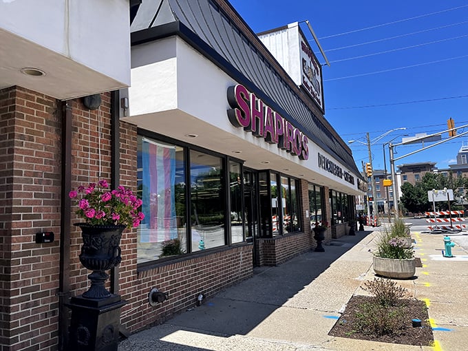 The iconic red Shapiro's sign beckons hungry travelers like a delicatessen lighthouse, promising sandwich salvation to all who enter its doors.