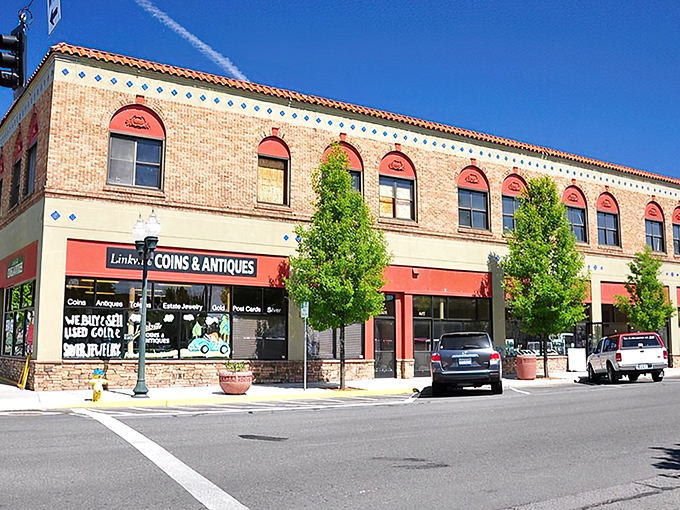 Historic brick buildings line downtown Klamath Falls, where Lindsey's Coins & Antiques invites treasure hunters to discover pieces of the past under bright blue Oregon skies.
