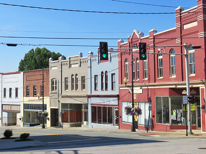 Historic Main Street whispers stories of bygone eras through its colorful brick facades, where hanging flower baskets add charm to this quintessential Southern downtown.
