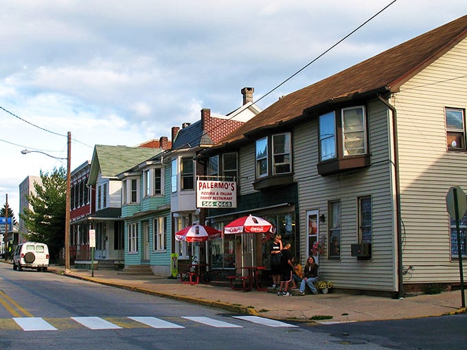 Palermo's Pizza stands as a colorful sentinel on Hummelstown's Main Street, where red umbrellas beckon like culinary lighthouses guiding hungry travelers home.
