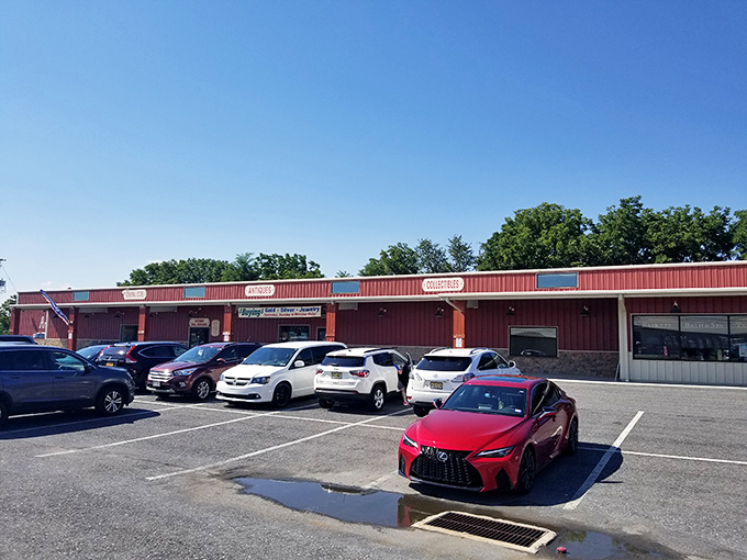 The iconic red exterior of Cackleberry Farm Antique Mall stands like a time machine in Paradise, beckoning treasure hunters with its rustic charm and promise of discoveries.