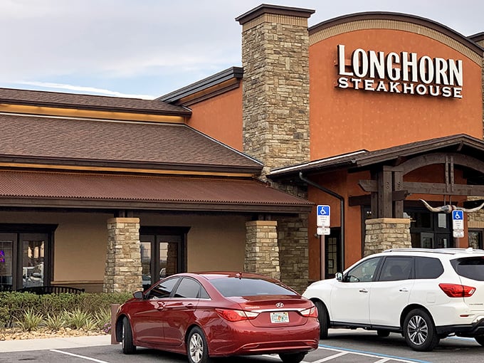 The Western-inspired facade of LongHorn Steakhouse stands like a carnivore's oasis amid Orlando's tourist landscape, promising refuge for the steak-starved traveler.
