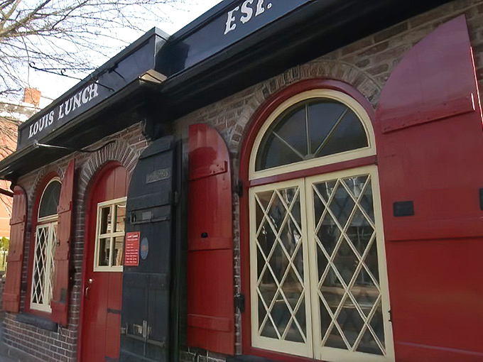 The little red brick building that changed America's culinary landscape forever. Louis' Lunch stands proudly in New Haven, a burger shrine disguised as a modest diner.