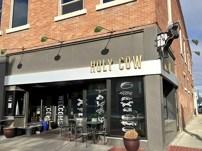 Gold lettering against a sleek gray facade announces your arrival at burger paradise. The crowned cow silhouette promises a royal feast awaits.
