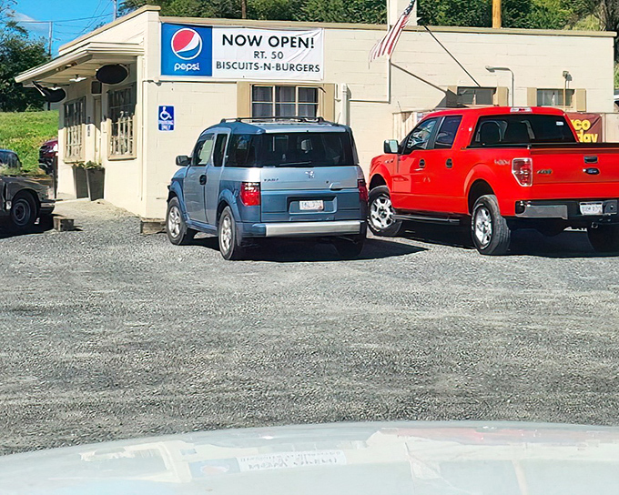 The humble exterior of Rt.50 Biscuits & Burgers glows with promise at dusk, string lights beckoning hungry travelers like a culinary lighthouse in Romney.