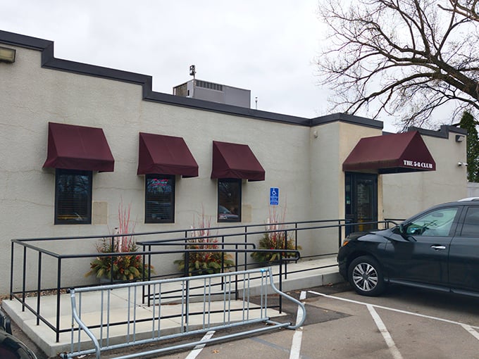 The unassuming exterior of 5-8 Club hides culinary greatness behind those burgundy awnings, proving that in Minnesota, legendary burgers don't need fancy facades.