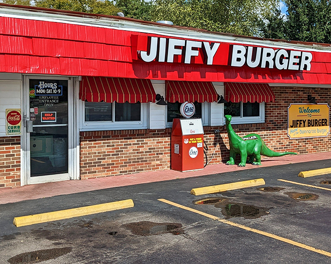 The green Sinclair dinosaur stands guard outside Jiffy Burger like a prehistoric bouncer who's really into comfort food. Red awnings and vintage gas pumps complete this time-travel tableau.