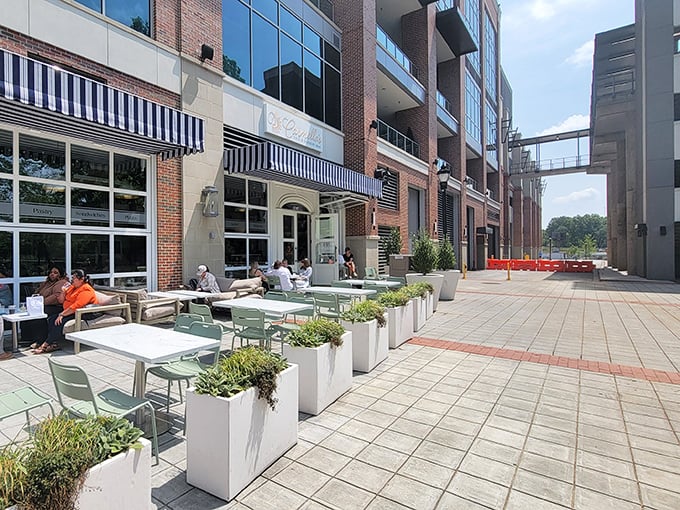 Carmella's elegant storefront glows like a beacon for dessert lovers, with its classic black and white awnings promising sweet sophistication inside.