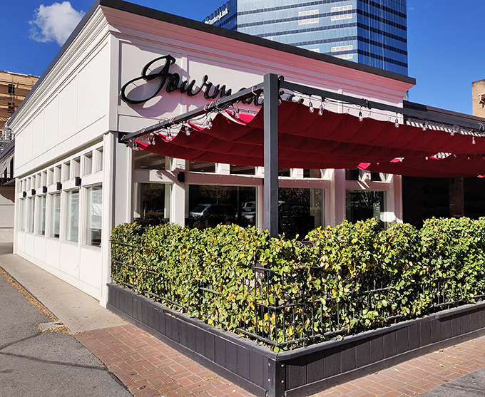 Gourmandise's charming exterior with vibrant red awnings and hanging flower baskets creates an instant European escape in downtown Salt Lake City.
