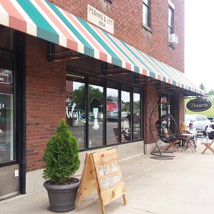The colorful striped awning beckons like a dessert rainbow, promising sweet treasures inside this charming Bridgeport brick storefront.