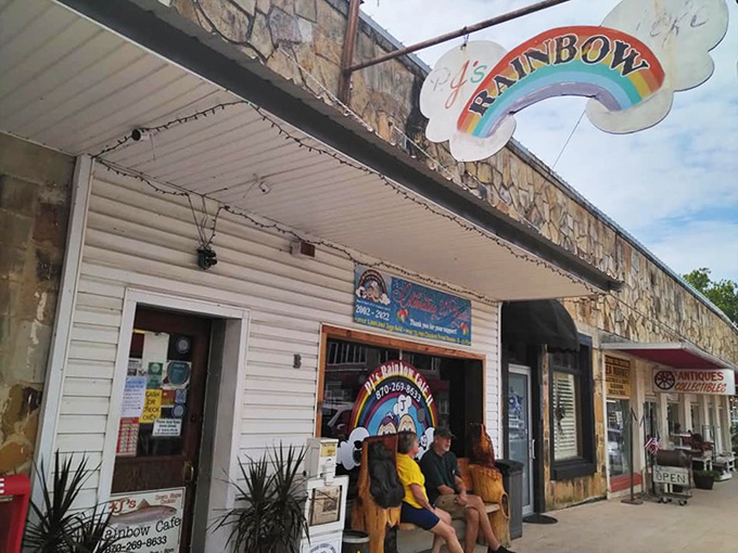 The rainbow sign beckons like a promise – this unassuming stone facade in Mountain View hides culinary treasures worth discovering.