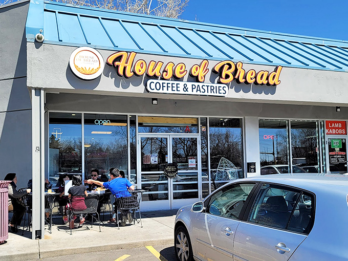 The blue-roofed sanctuary of carbs announces itself with golden lettering that practically whispers, "Yes, this is where the good stuff lives."