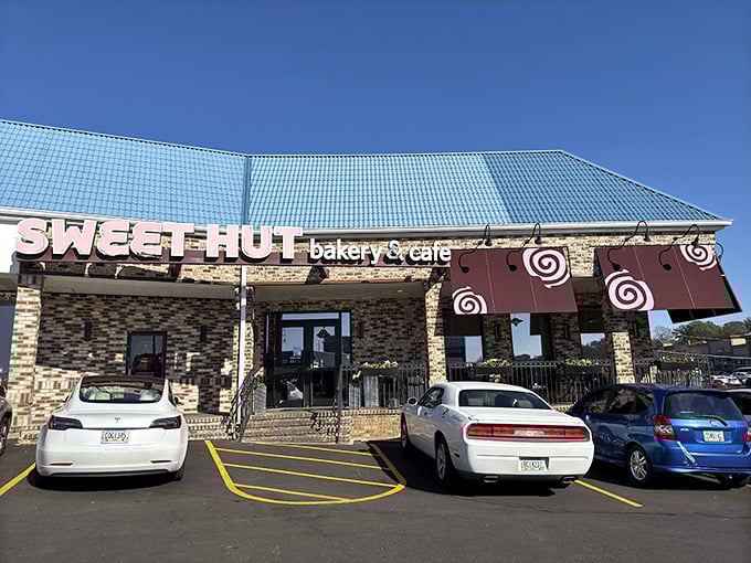 The distinctive blue roof and stone facade of Sweet Hut beckons like a beacon of baked goodness in Doraville's culinary landscape.