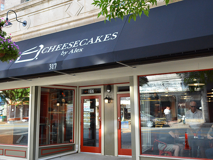 The navy blue awning of Cheesecakes by Alex beckons like a dessert lighthouse on Greensboro's Elm Street, promising sweet salvation for the sugar-deprived.