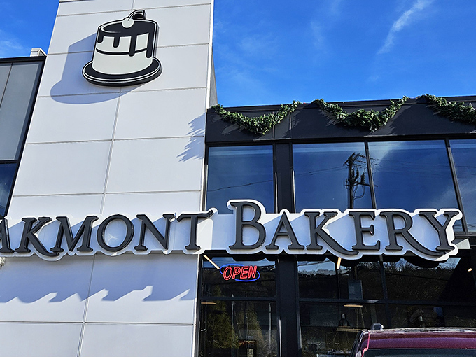 The iconic Oakmont Bakery sign stands like a beacon of hope for the sugar-deprived. This modern temple of temptation promises sweet salvation inside.