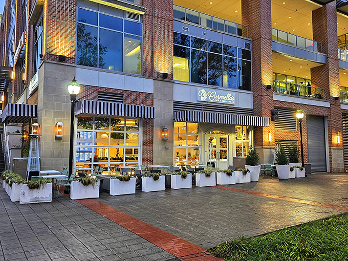 Carmella's elegant storefront glows like a beacon for dessert lovers, with its classic black and white awnings promising sweet sophistication inside.