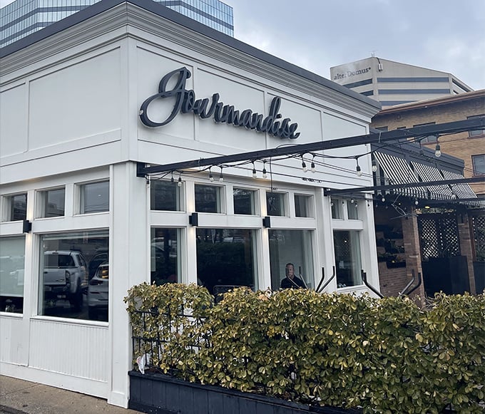Gourmandise's charming exterior with vibrant red awnings and hanging flower baskets creates an instant European escape in downtown Salt Lake City.