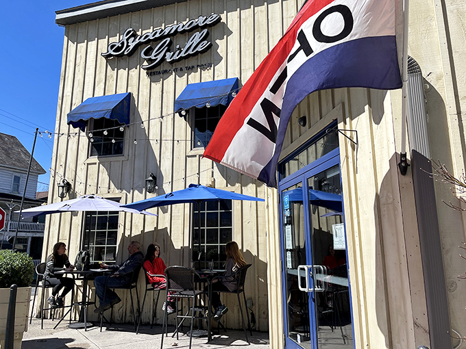 The iconic tan exterior with blue accents and welcoming patio whispers "come inside" like a culinary siren song.