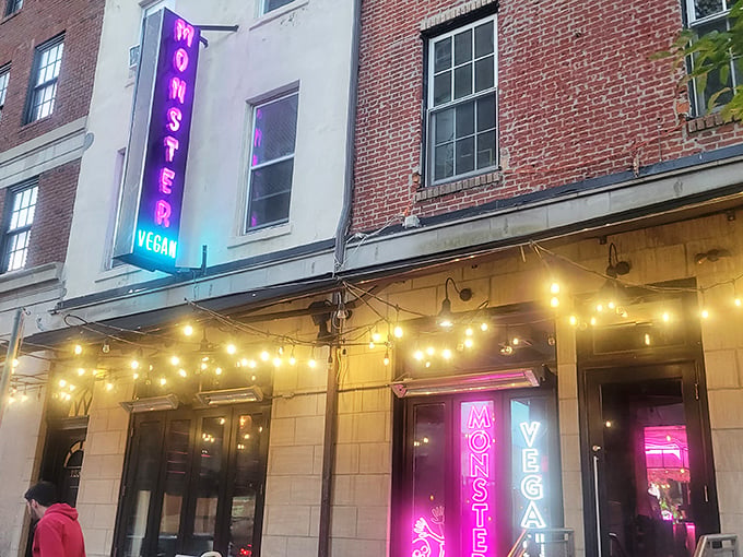 The neon-lit entrance to Monster Vegan beckons like a pink-hued beacon for the hungry and curious. Metal tables outside offer a perfect people-watching perch.