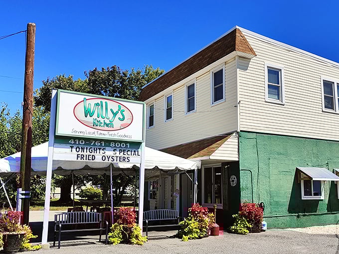 Willy's Kitchen stands proudly in Glen Burnie, its mint-green exterior and vibrant flower boxes promising comfort food treasures within. The sign's special announcement of fried oysters is just a bonus.