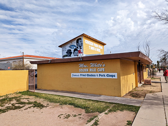 That cheerful yellow exterior and vibrant mural practically shout "comfort food paradise" from across the street.