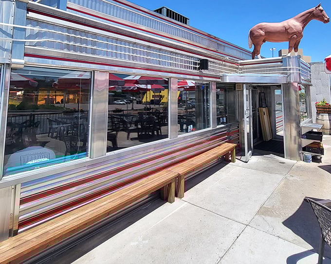 The gleaming chrome exterior of Davies' Chuck Wagon Diner shines like a time machine to the 1950s, complete with those classic horizontal stripes that scream "American optimism."