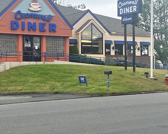 The iconic blue sign of Cromwell Diner stands like a beacon for hungry travelers, promising comfort food salvation just off Route 372. 