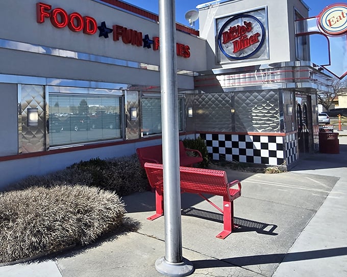 The gleaming chrome exterior of Dixie's Diner shines like a beacon of hope for hungry travelers, its classic checkerboard trim promising authentic American comfort food inside.
