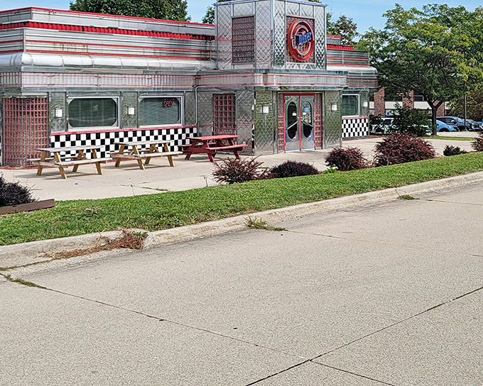 The gleaming stainless steel exterior with classic checkered trim promises a time-traveling culinary adventure before you even step inside.