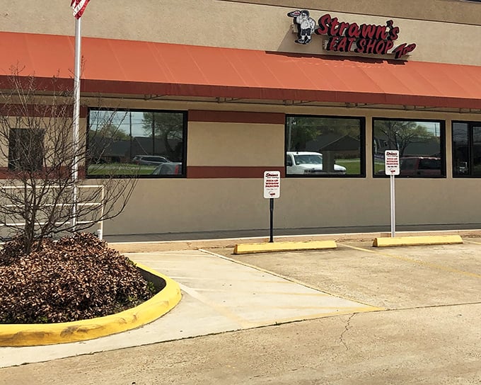 The unassuming red awning of Strawn's Eat Shop Too stands like a beacon to hungry travelers. No fancy frills needed when the food inside speaks volumes.
